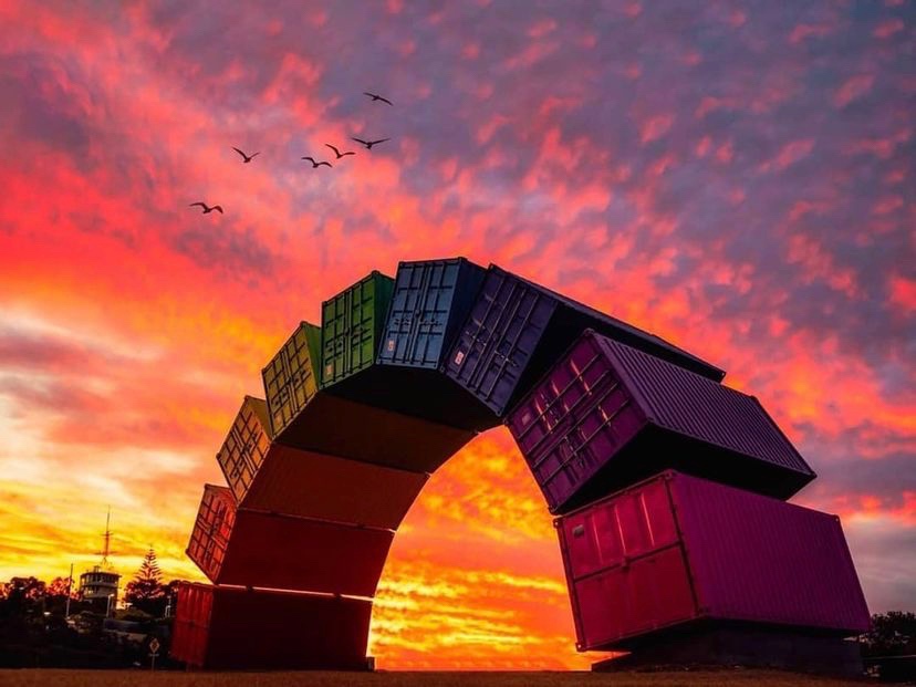 A beautiful pinkish sunset overlooks the ‘Containbow’ art installation ...